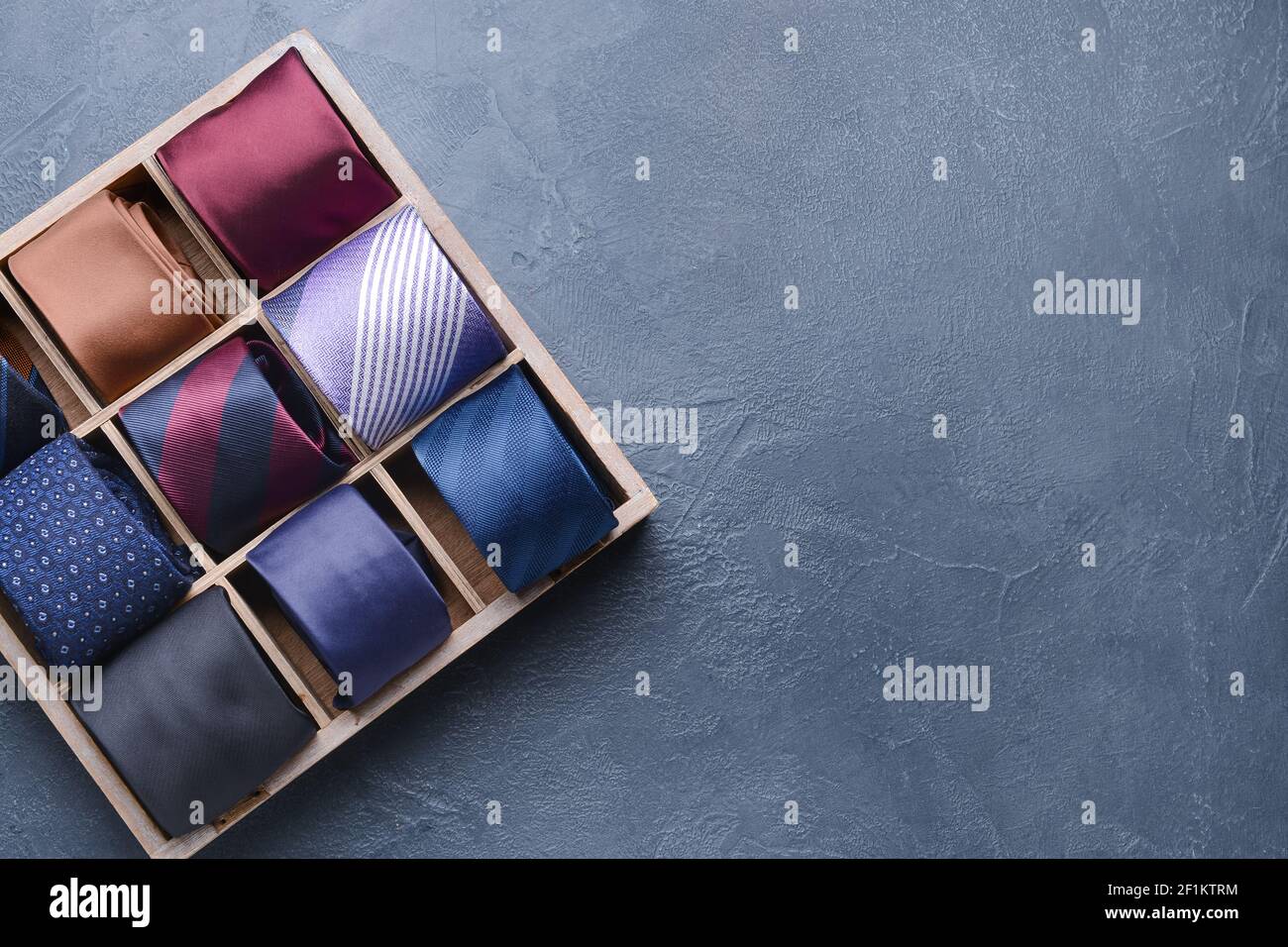 Box with stylish neckties on dark background Stock Photo - Alamy