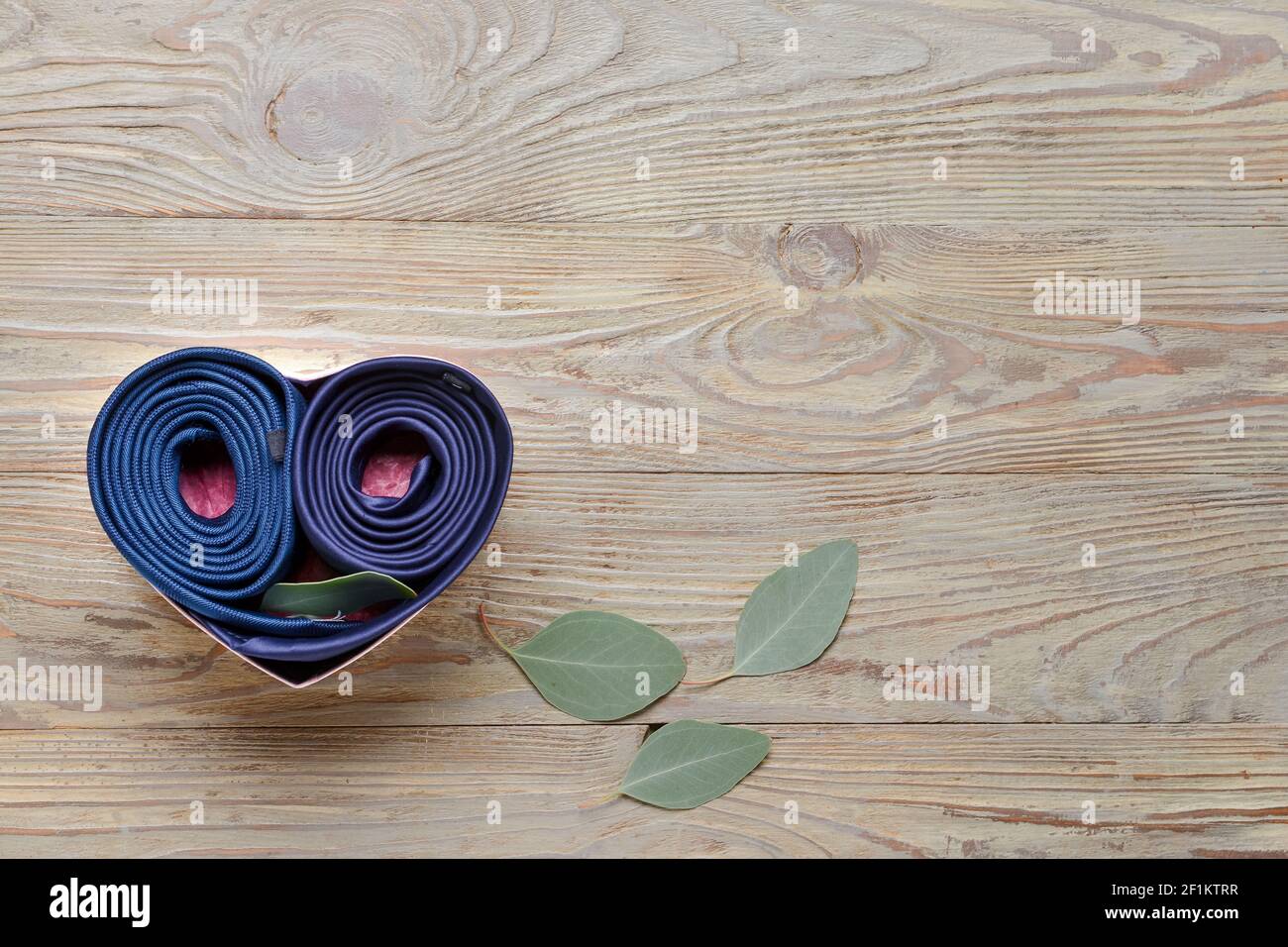 Heart-shaped box with stylish neckties on wooden background Stock Photo ...