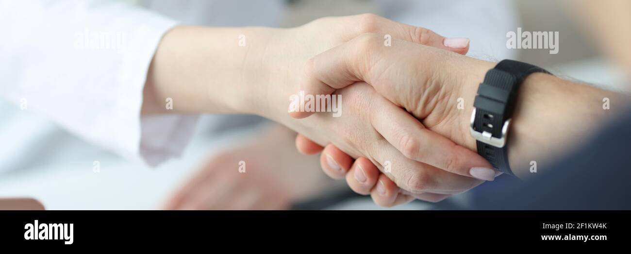 Closeup of doctor and patient handshake in clinic Stock Photo - Alamy