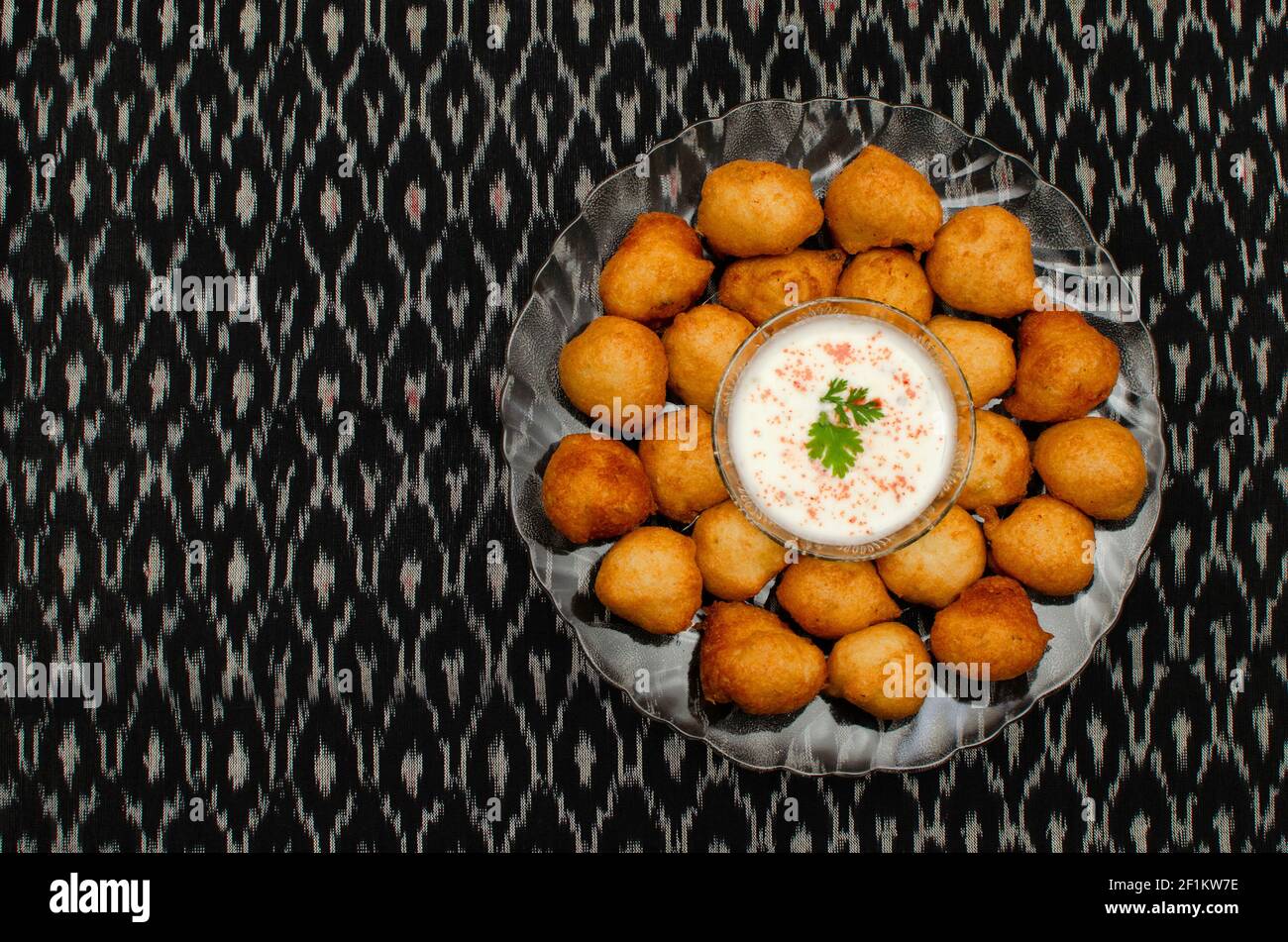 Dahi Wada, famous Indian street food or snacks in transparent colored ...
