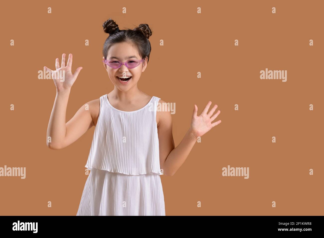 Happy little girl on color background Stock Photo - Alamy
