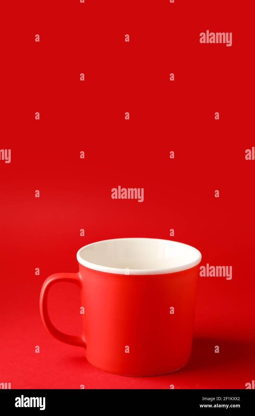Empty cup on color background Stock Photo - Alamy