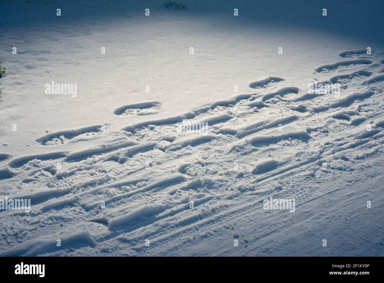 Spotlight on footsteps in the snow Stock Photo - Alamy