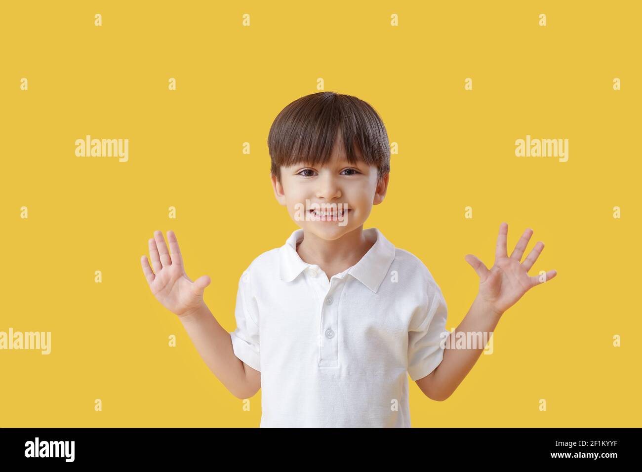 Cute little boy on color background Stock Photo - Alamy