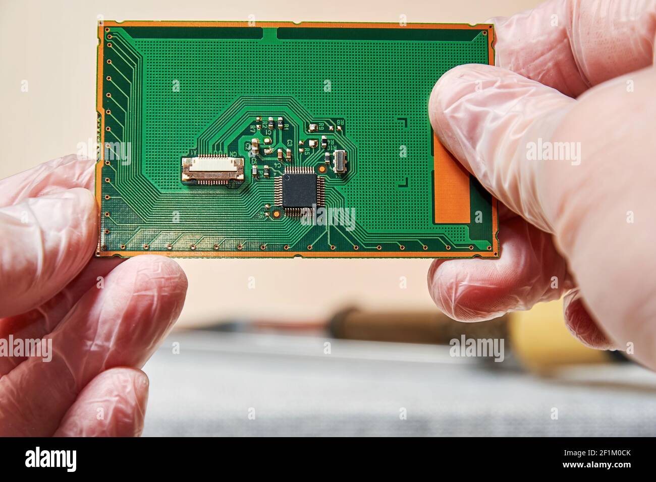 An engineer keeps and examines the PCB with a microchip in tech ...