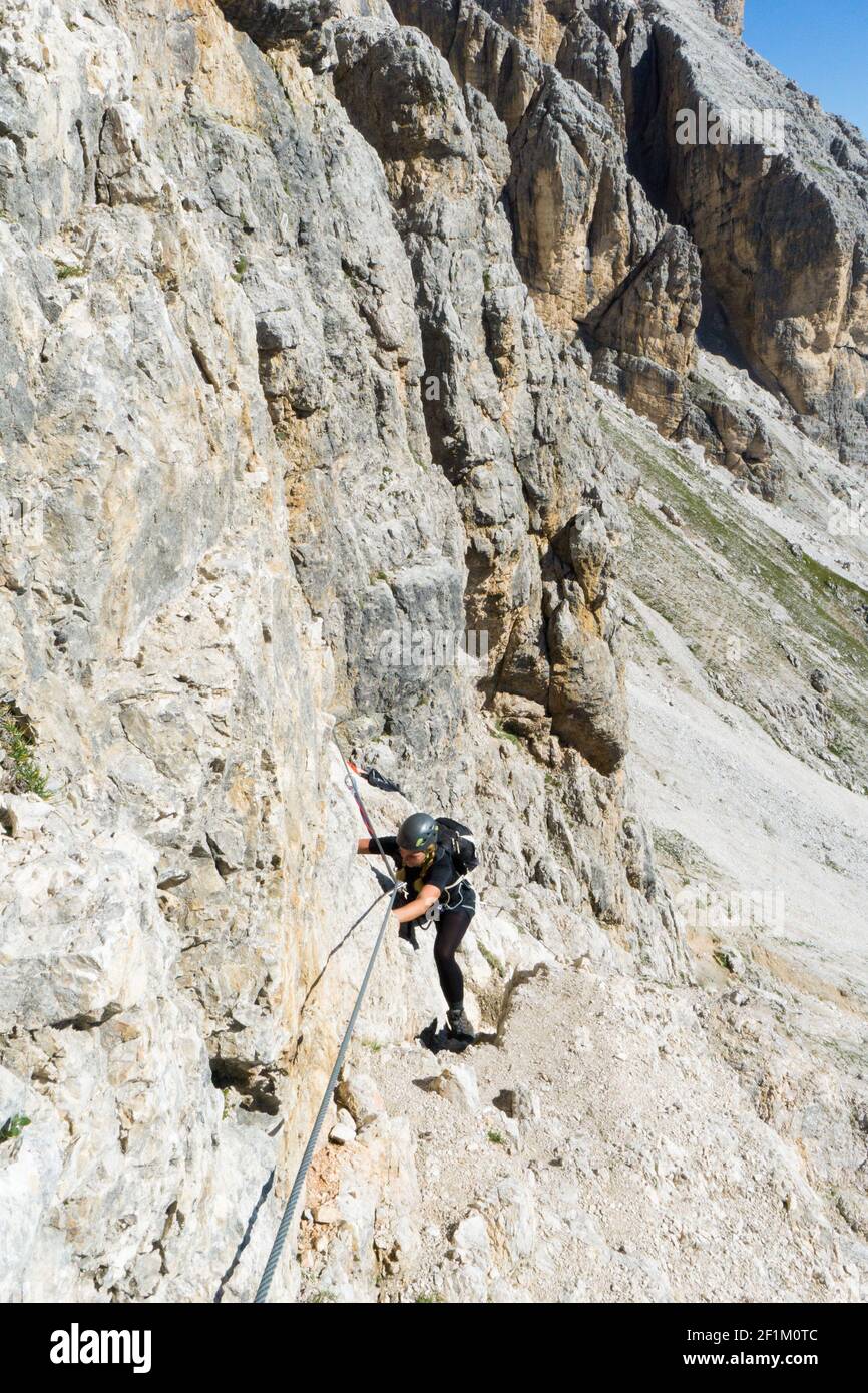 Attractive blonde female mountain climber in the Dolomites of Italy ...