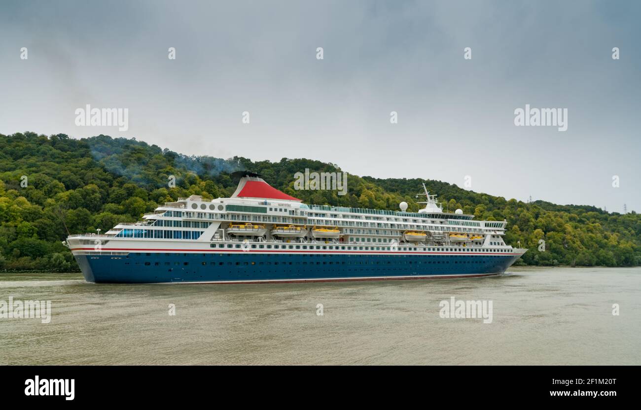 Blue and white cruise ship traveling along the Seine River from Paris ...