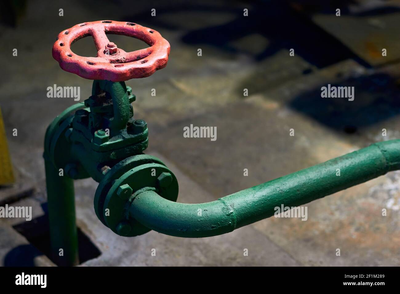 Industrial green chemical petrochemical retro style valve closeup with ...