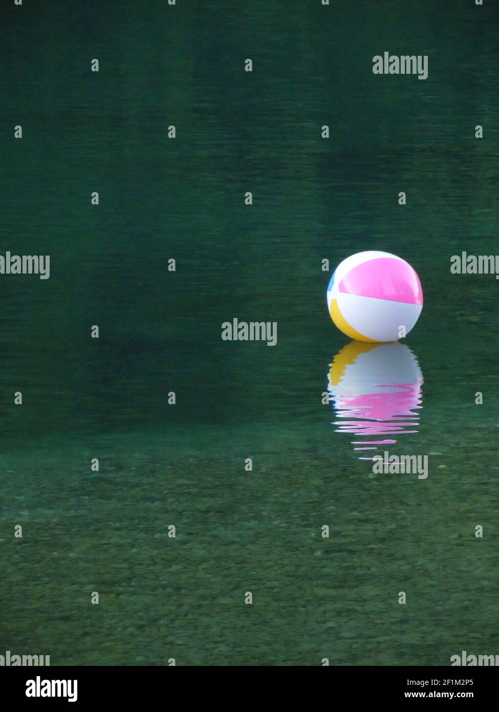 Colorful beach ball floating on the water Stock Photo - Alamy