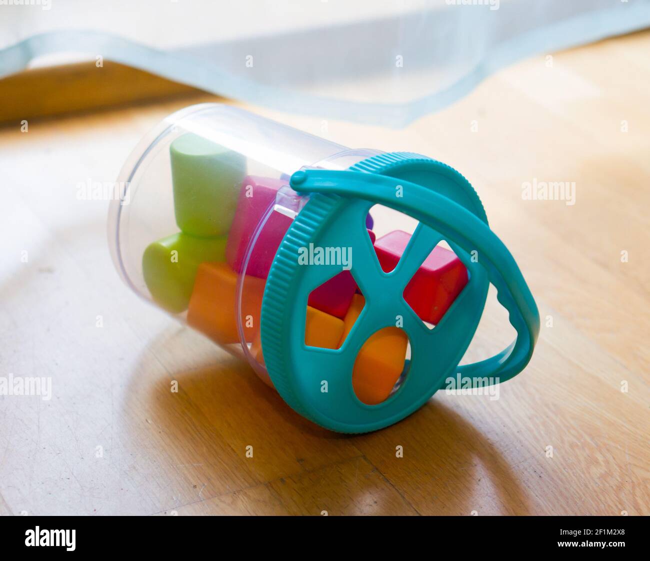 Plastic toy bucket on the floor Stock Photo - Alamy