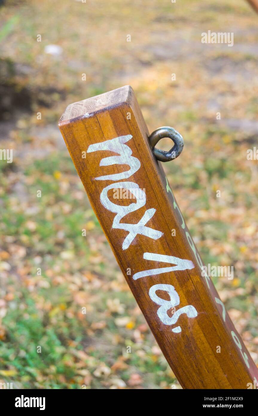 Wooden pole with weight warning Stock Photo - Alamy