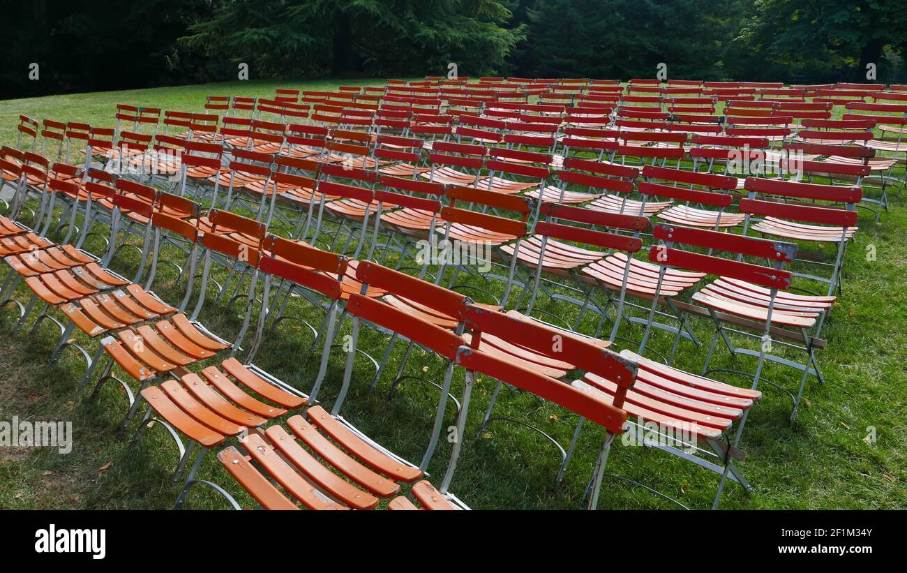 Empty audience red seats in a park Stock Photo - Alamy