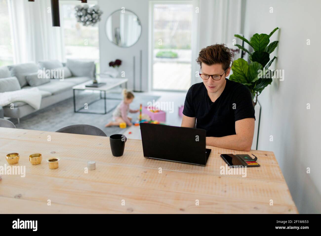 Man working at home laptop family hi-res stock photography and images ...
