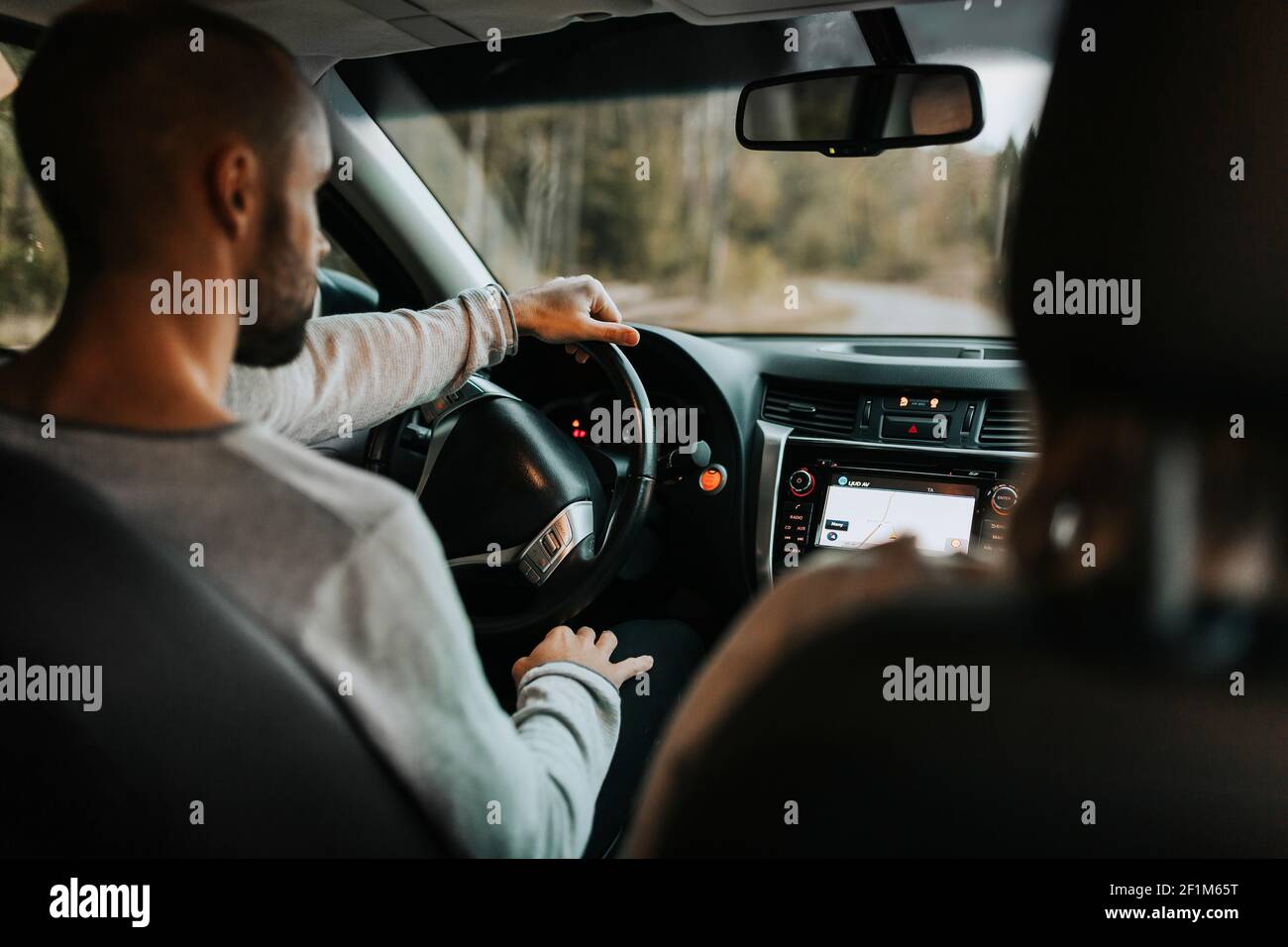 Rear view of man driving car Stock Photo - Alamy
