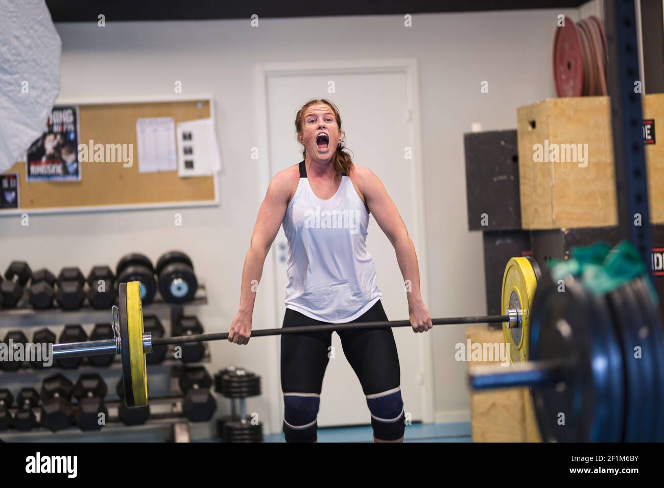Woman weightlifting in gym Stock Photo - Alamy