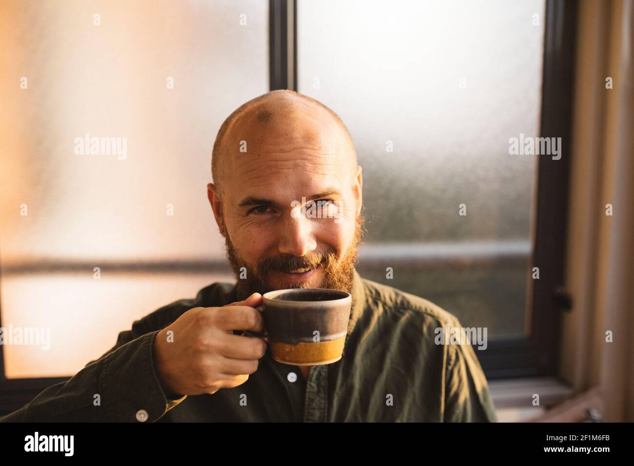 Smiling man drinking coffee Stock Photo - Alamy
