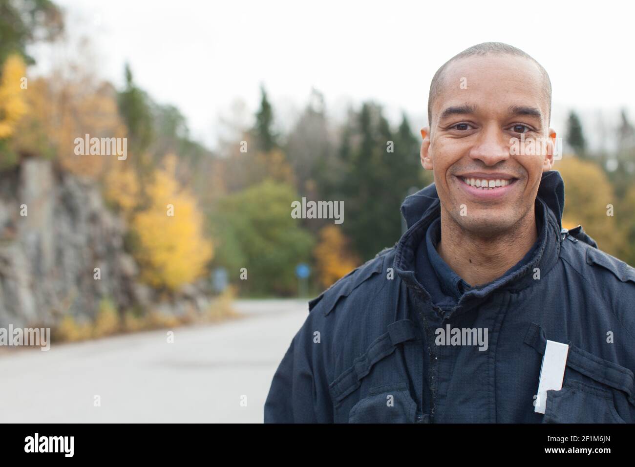 Smiling firefighter looking at camera Stock Photo - Alamy