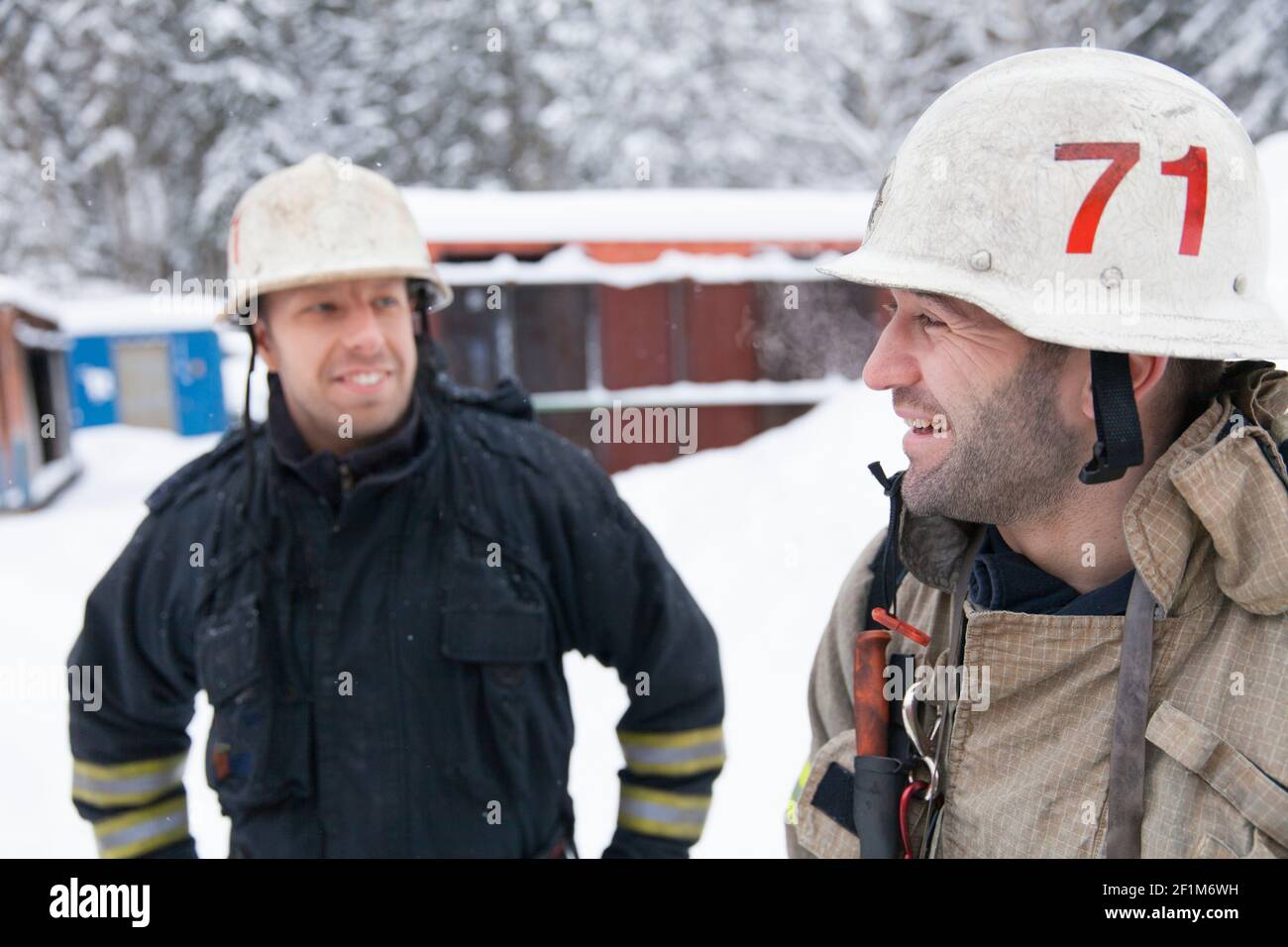 Smiling firefighters talking Stock Photo - Alamy