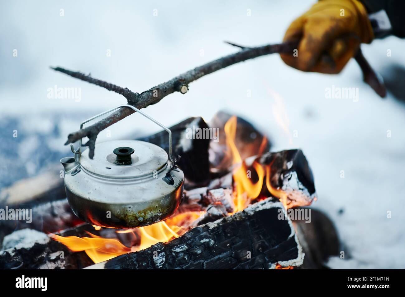 Kettle on stick over campfire Stock Photo - Alamy