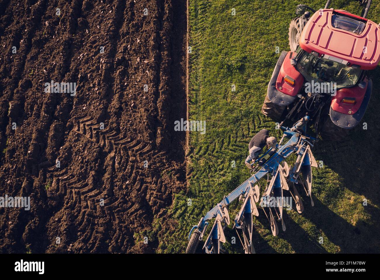 Tractor plowing field Stock Photo - Alamy