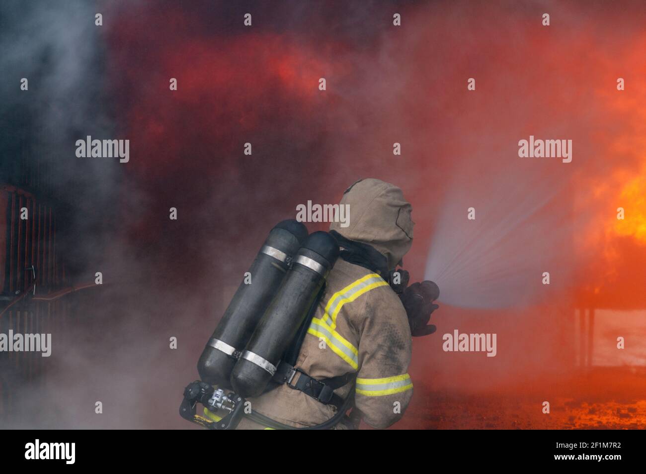 Fireman holding hose hi-res stock photography and images - Alamy