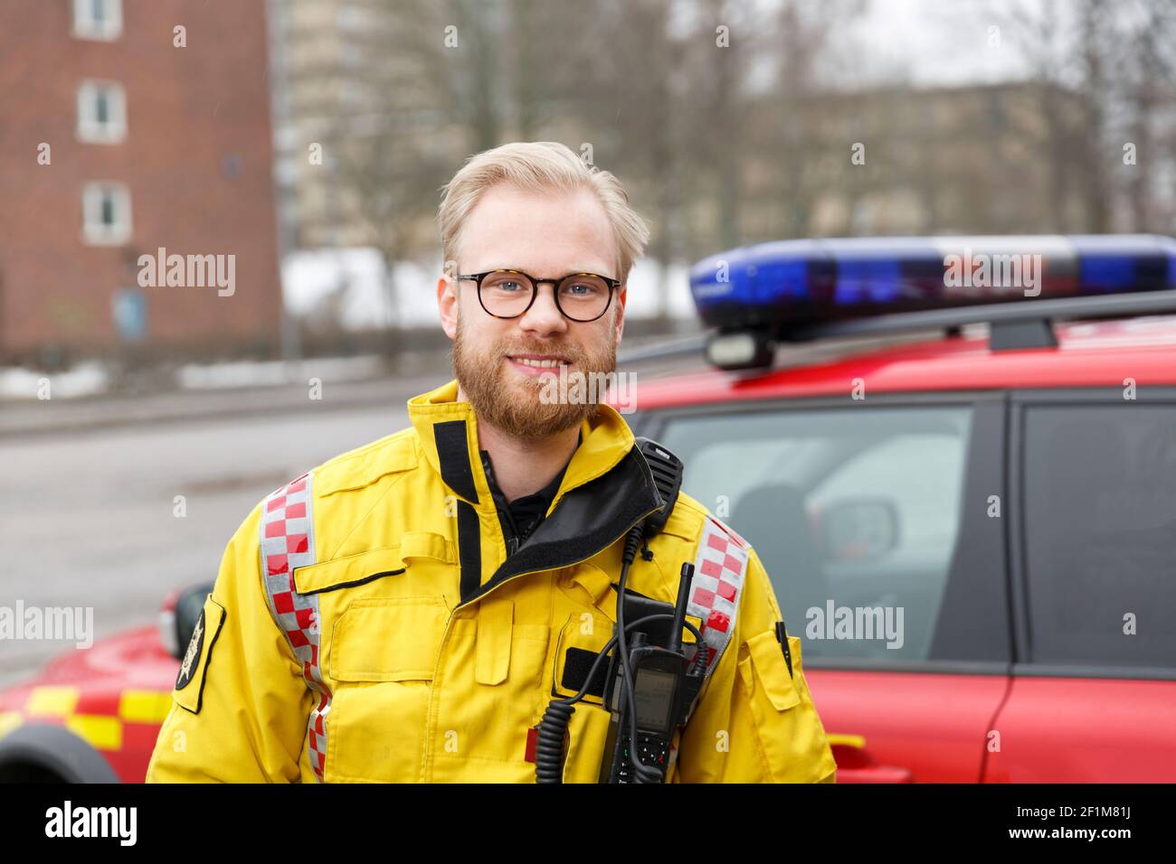 Smiling firefighter looking at camera Stock Photo - Alamy