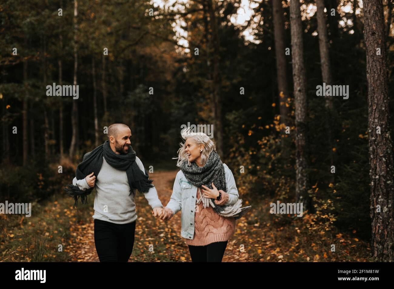 Young positive couple walking holding hi-res stock photography and ...