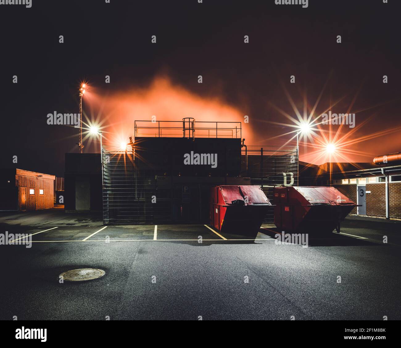 Large garbage containers at night Stock Photo - Alamy