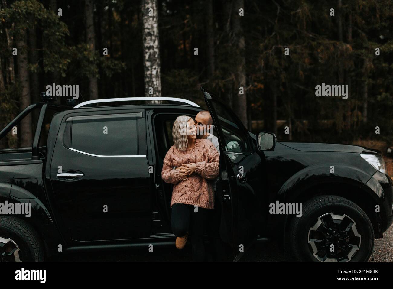 Couple hugging near car Stock Photo - Alamy