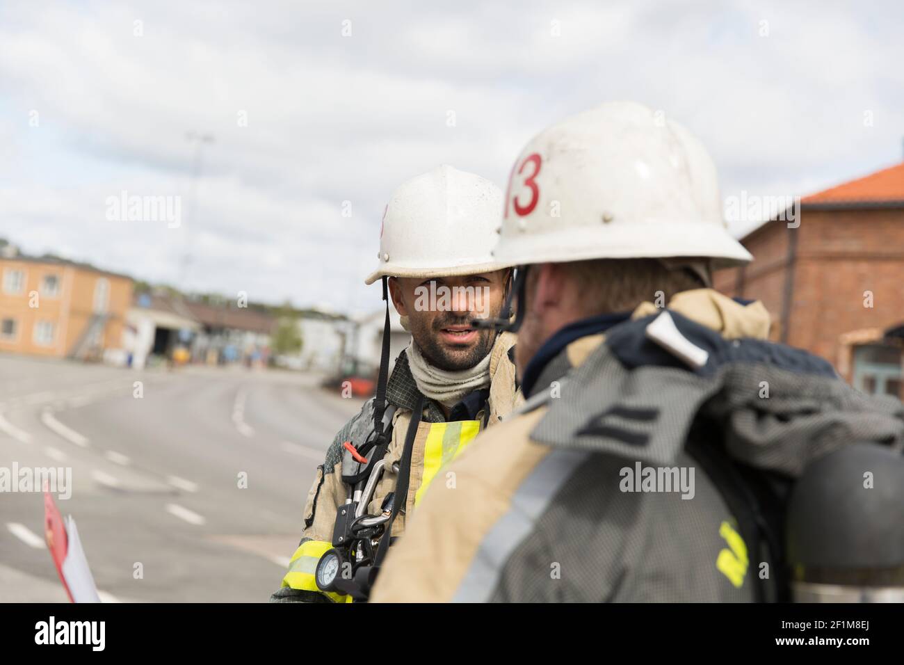 Firefighters talking together Stock Photo - Alamy