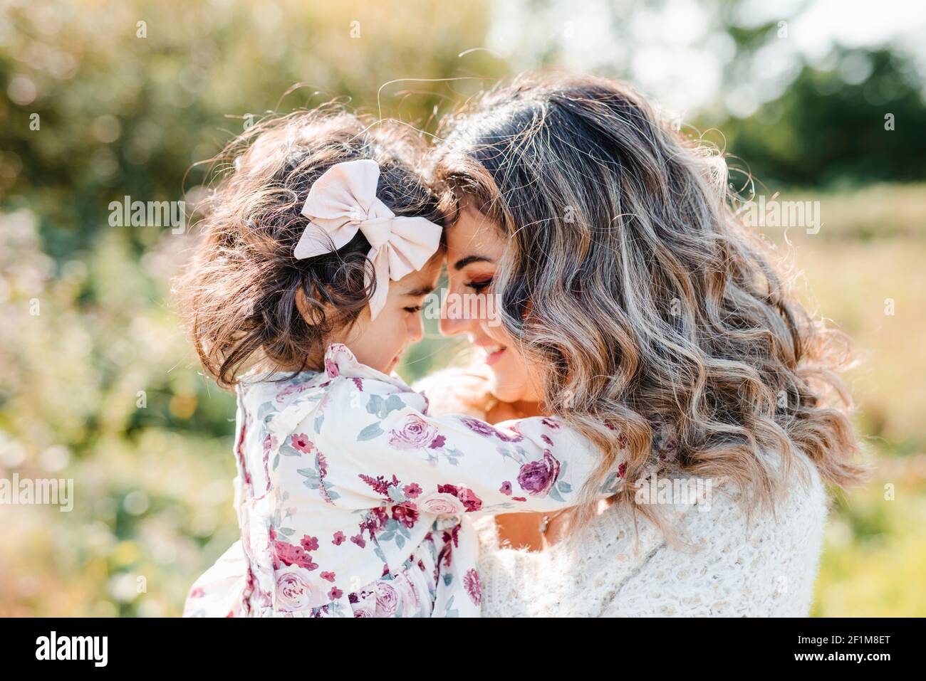 Mother and daughter looking at each other Stock Photo - Alamy