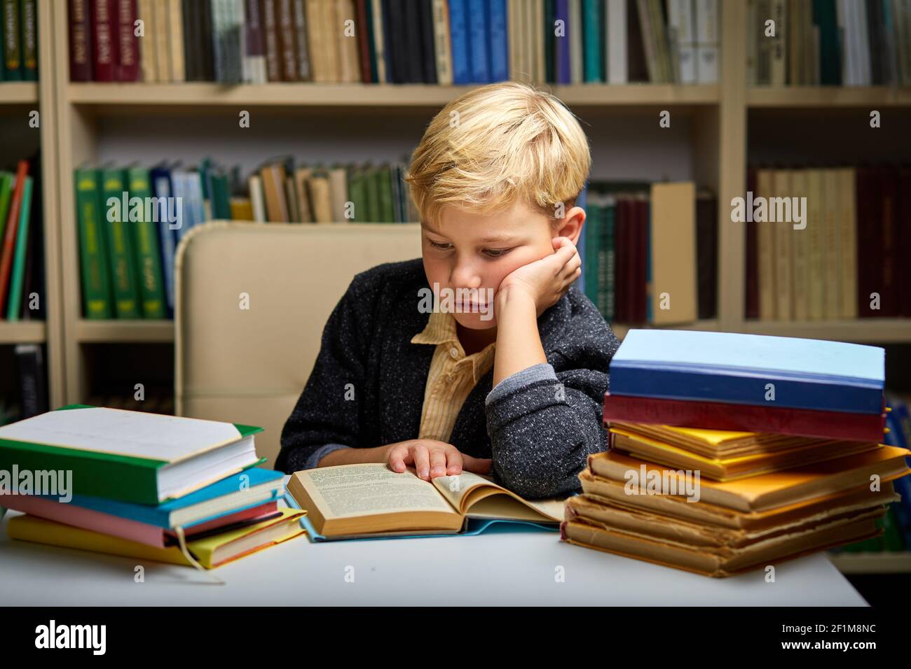 child boy under mental pressure while reading books preparing ...