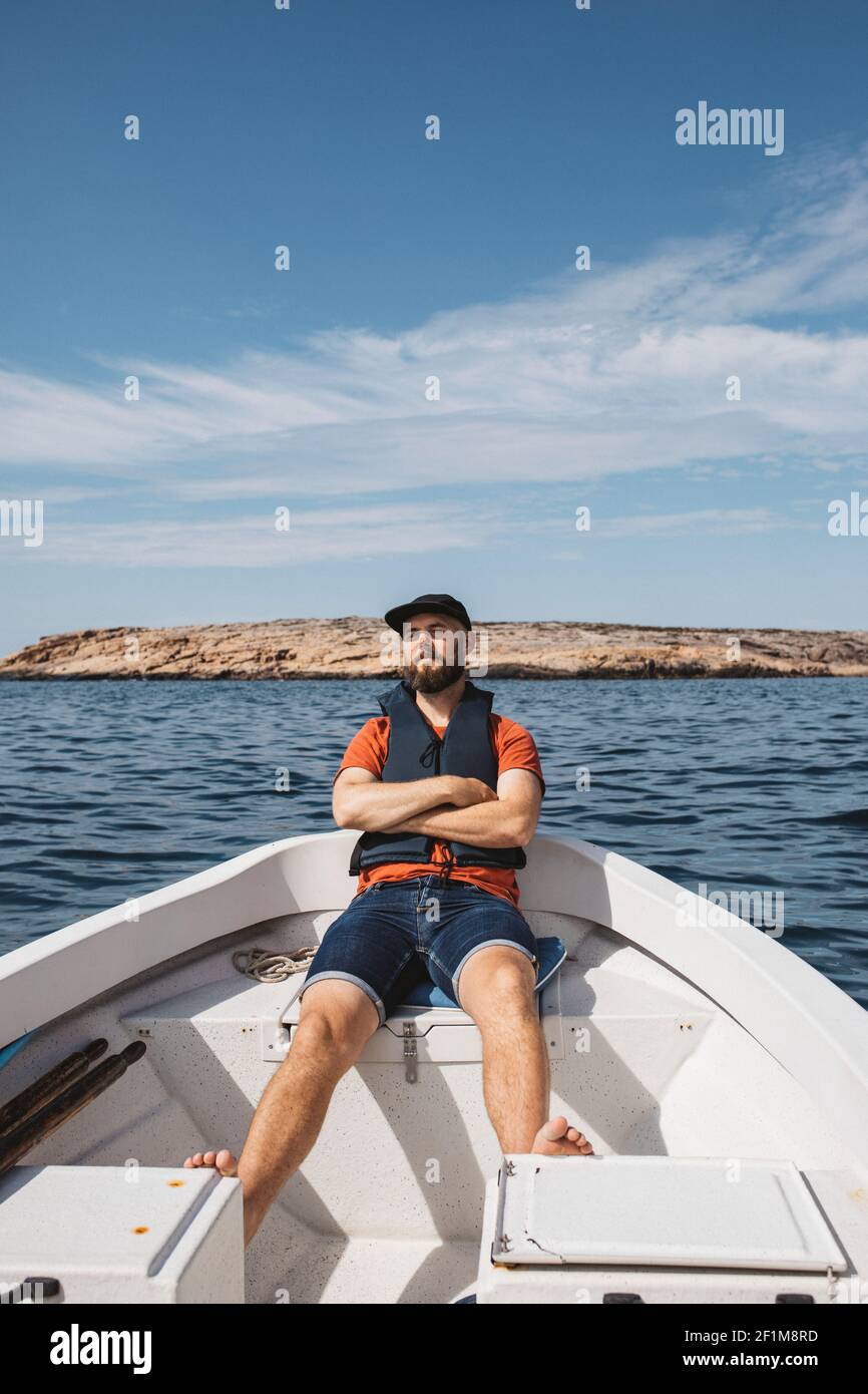 Man relaxing on boat Stock Photo - Alamy