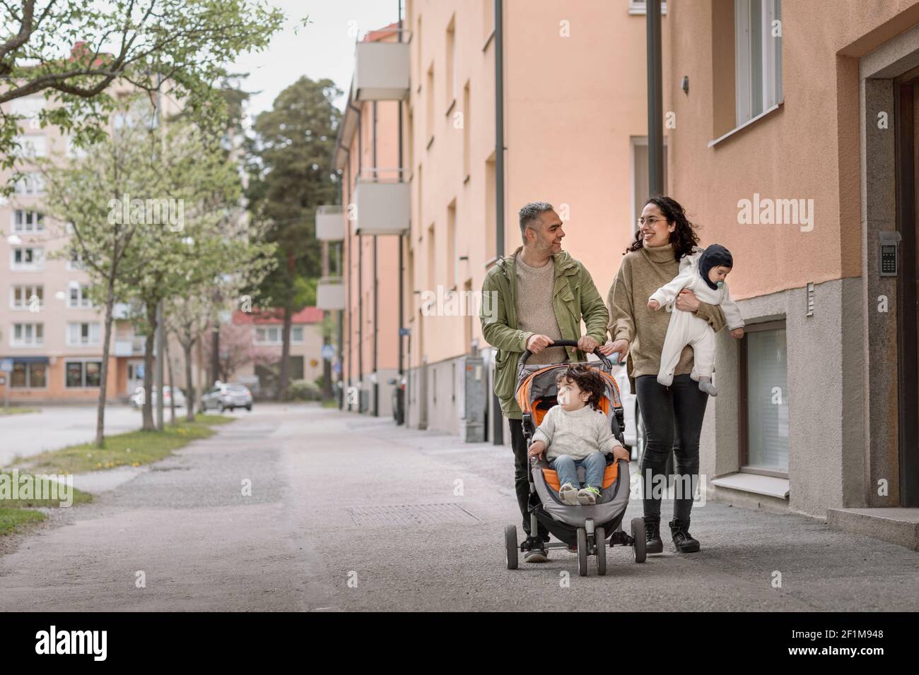 Parents with two children having walk Stock Photo - Alamy