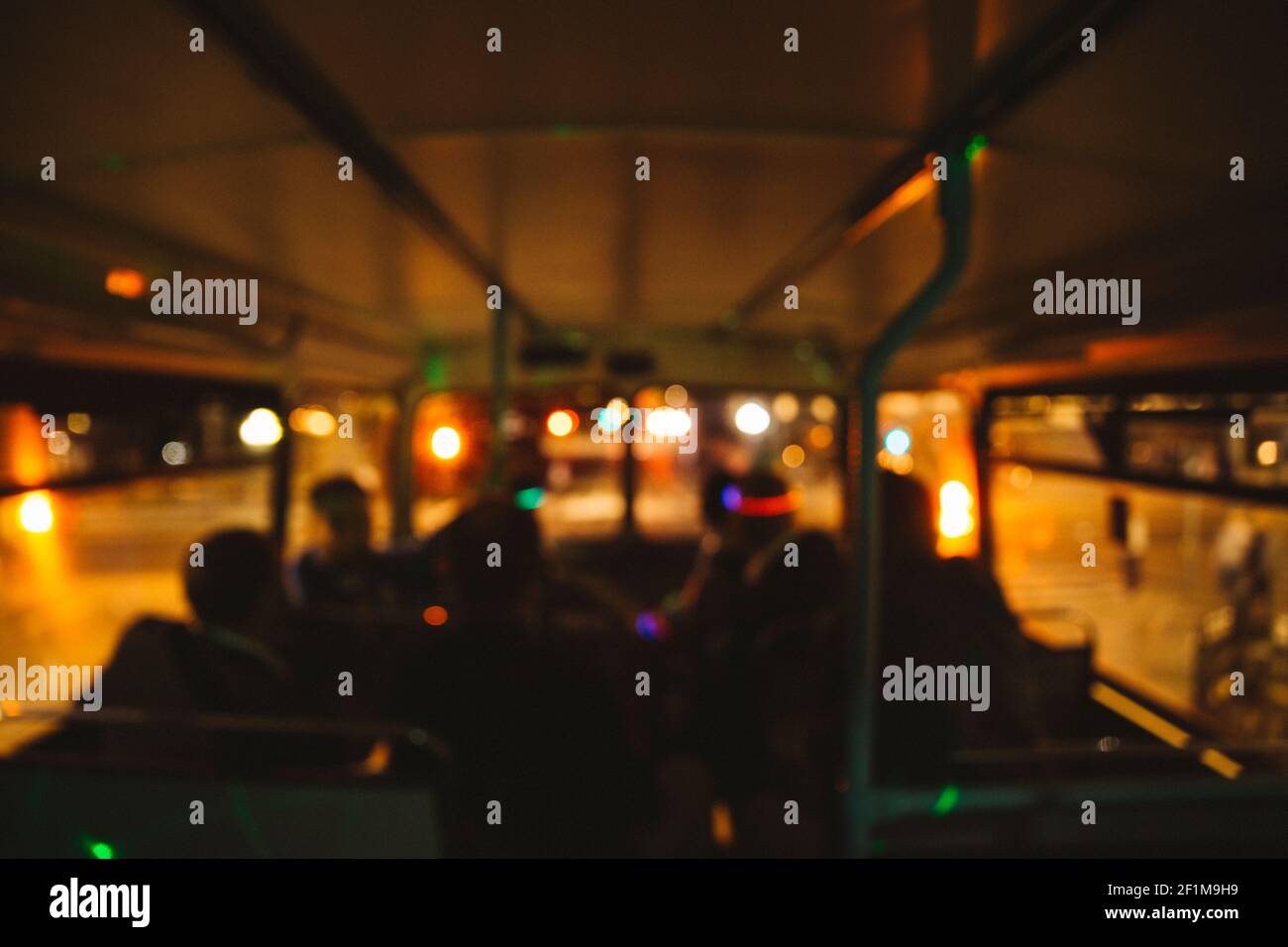 Defocused picture of passengers in bus at night Stock Photo - Alamy