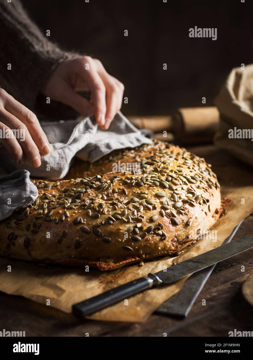 Hands covering freshly baked bread Stock Photo - Alamy