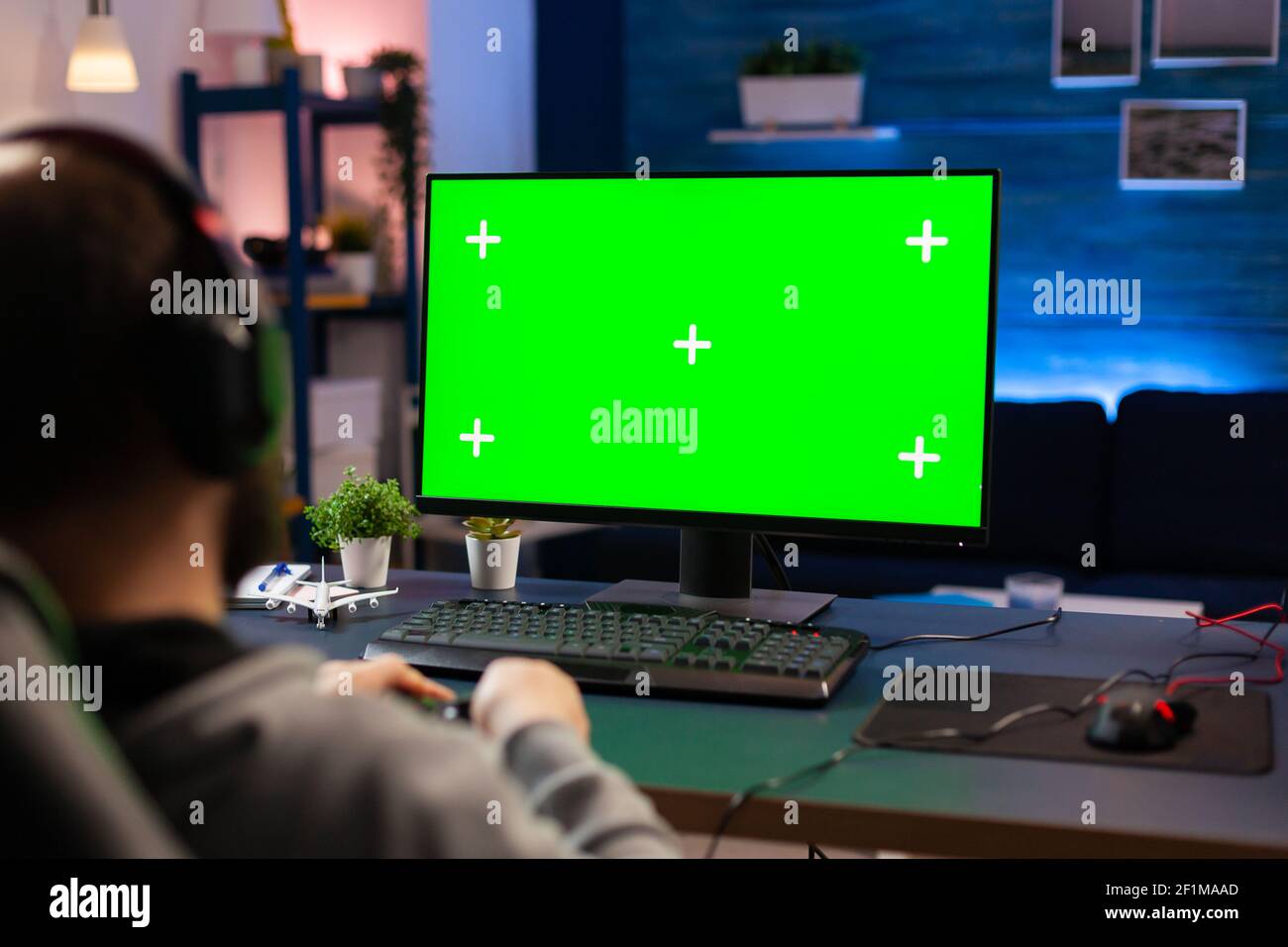 Professional player streaming videogames with green screen mock-up ...