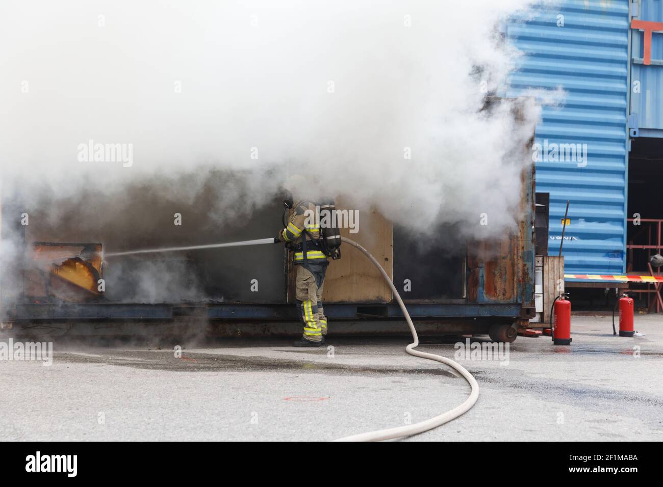 Fireman holding water hose hi-res stock photography and images - Alamy