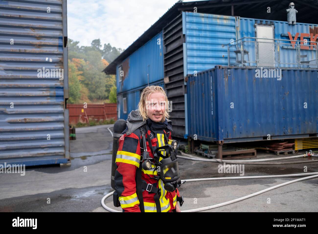 Smiling firefighter looking at camera Stock Photo - Alamy
