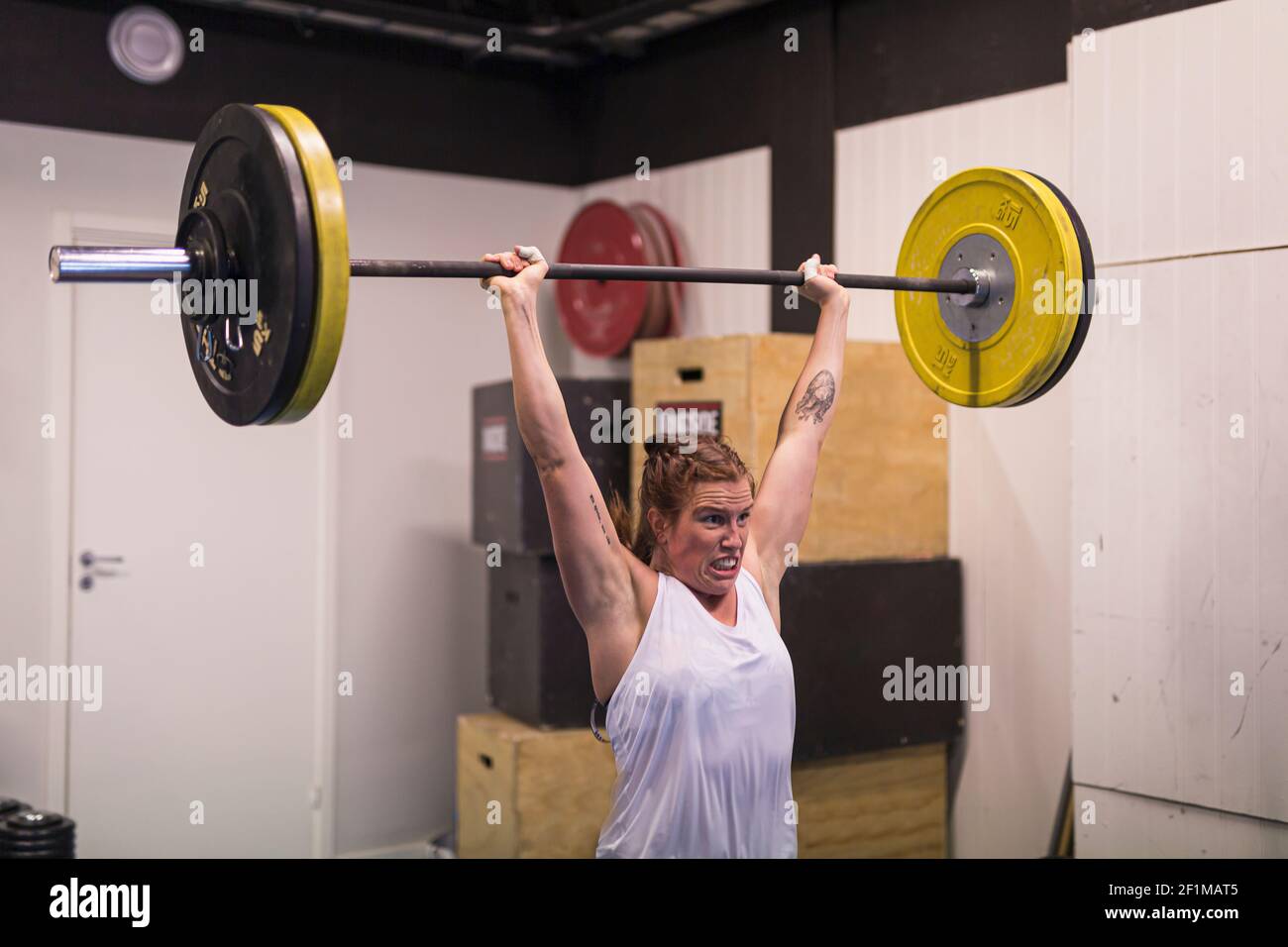 Woman weightlifting in gym Stock Photo - Alamy