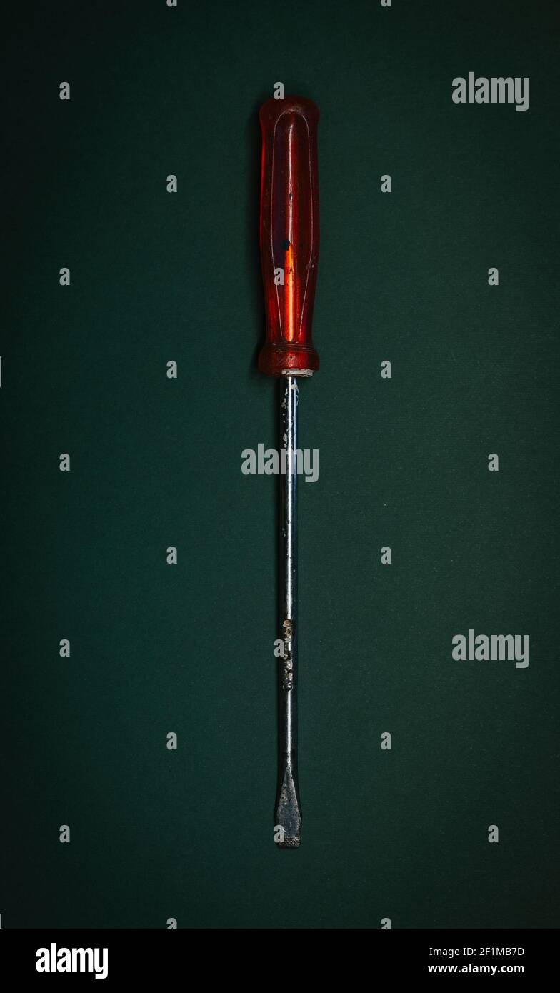 Screwdriver on grey background Stock Photo - Alamy