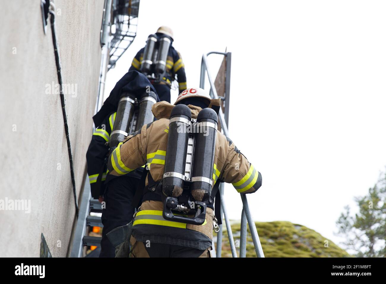 Low view of firefighters on stairs Stock Photo - Alamy
