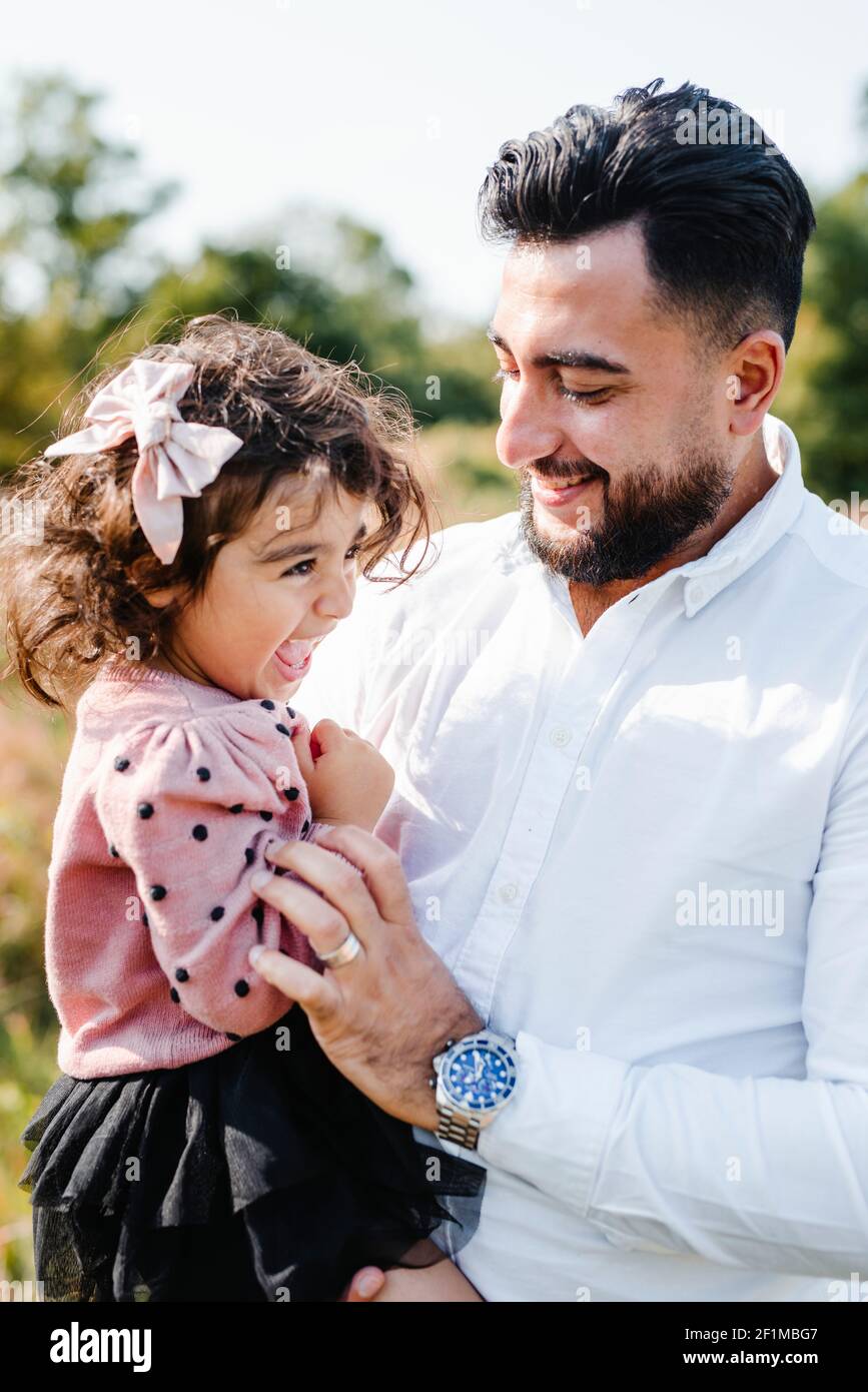 Father carrying daughter Stock Photo - Alamy