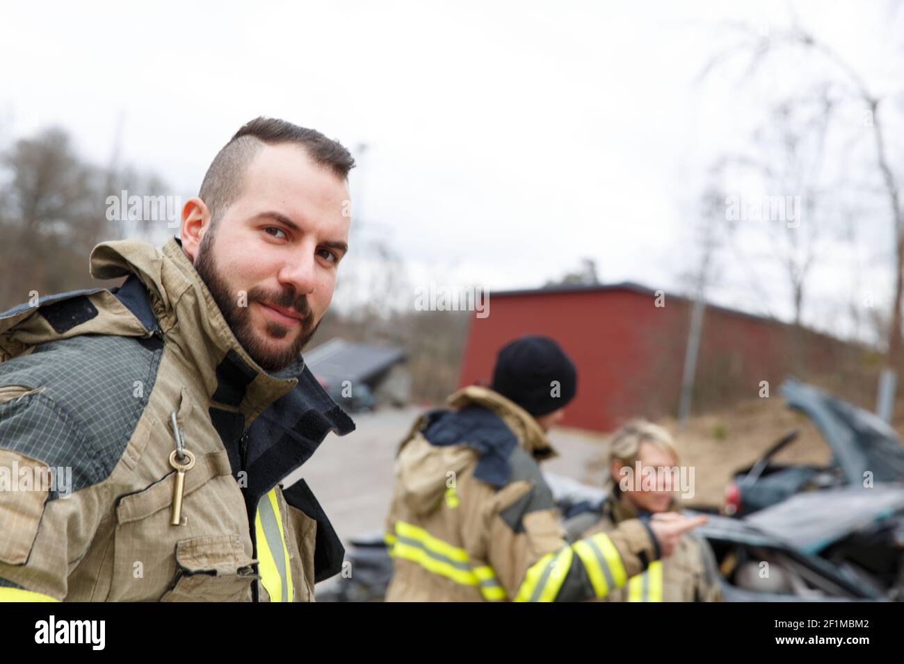 Smiling firefighter looking at camera Stock Photo - Alamy