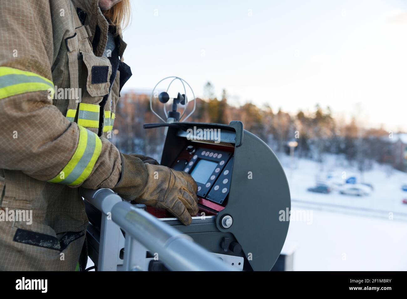 Mid section of firefighter using control panel Stock Photo - Alamy