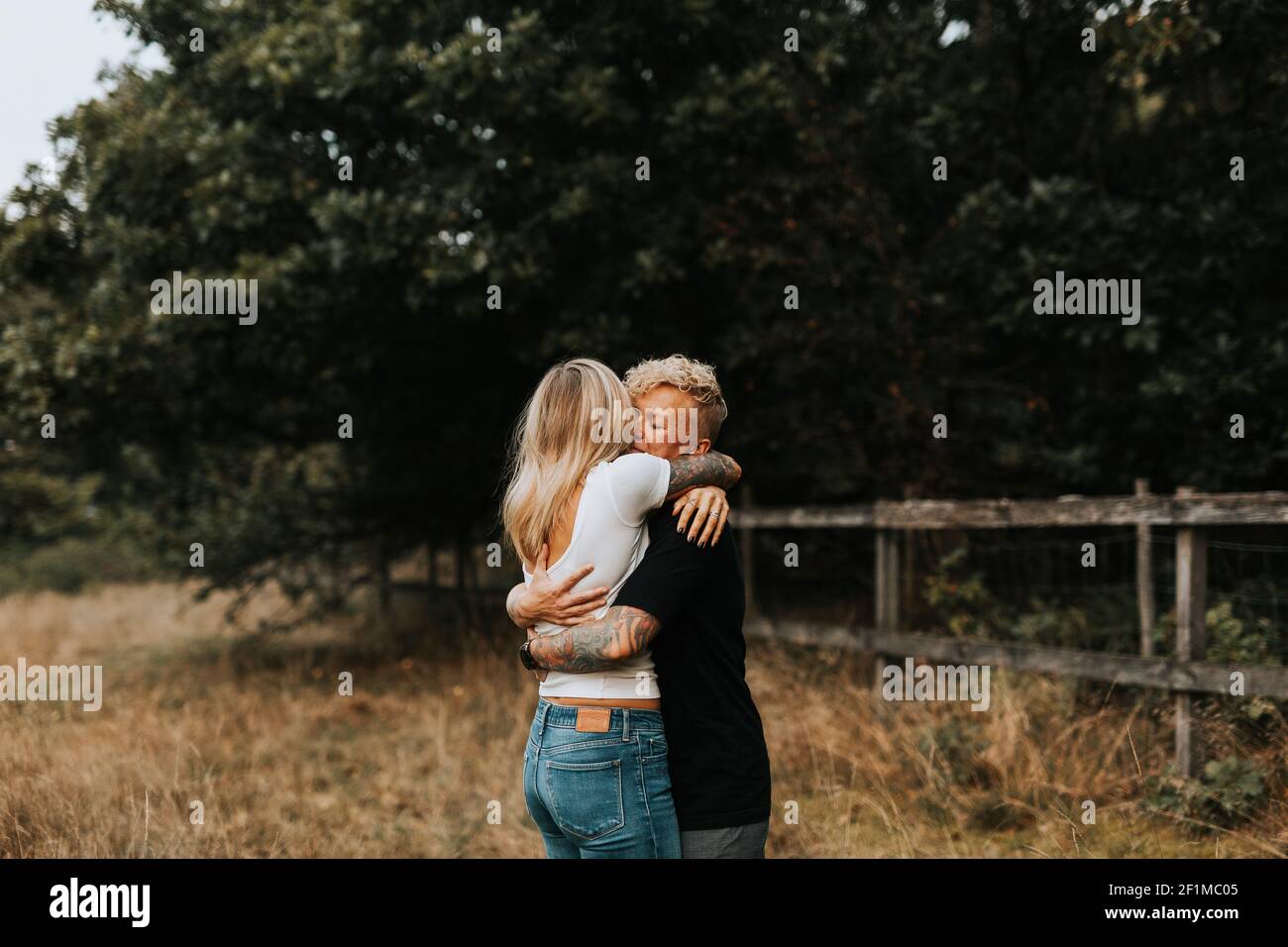 Female couple hugging Stock Photo - Alamy