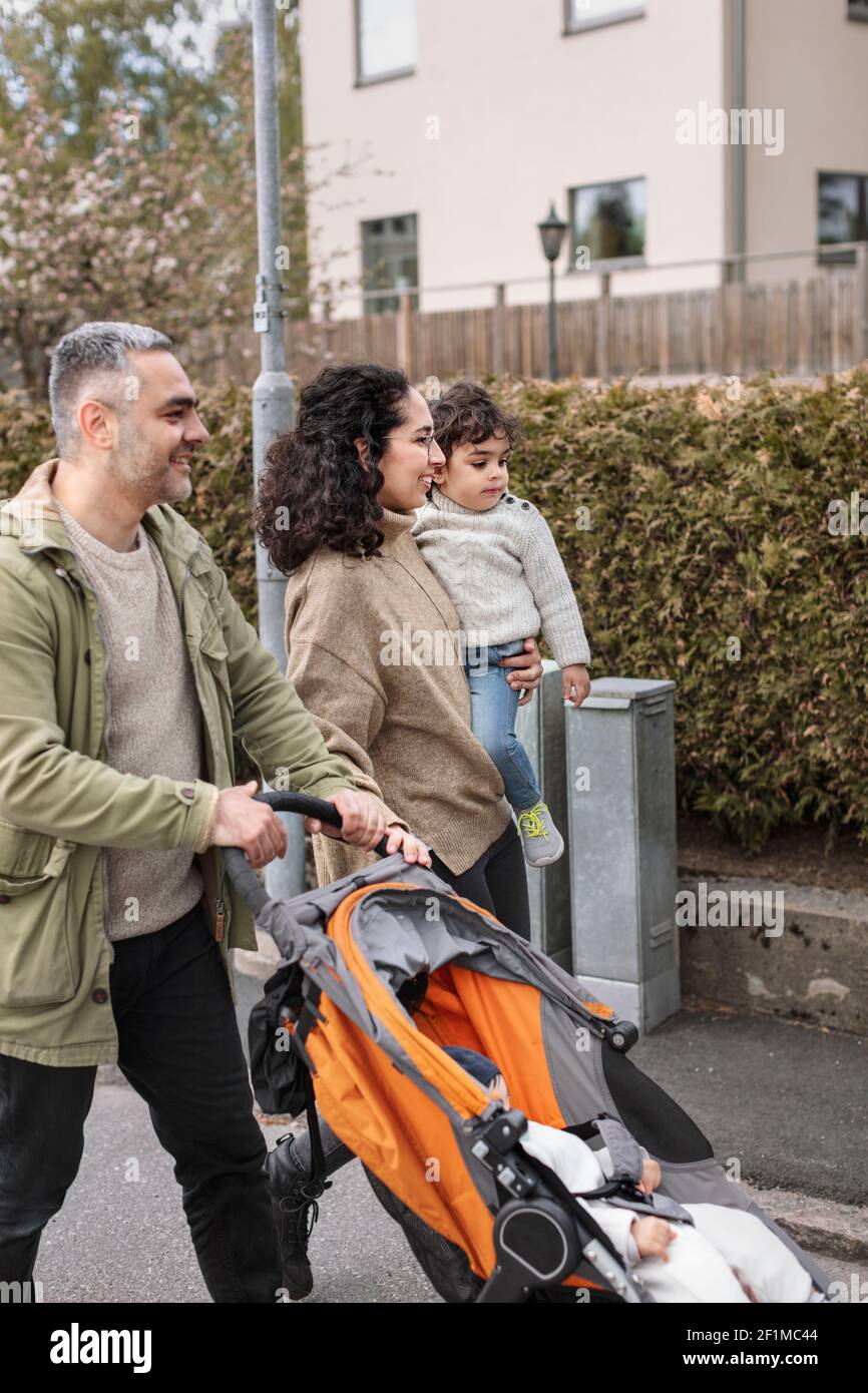 Parents with two children having walk Stock Photo - Alamy