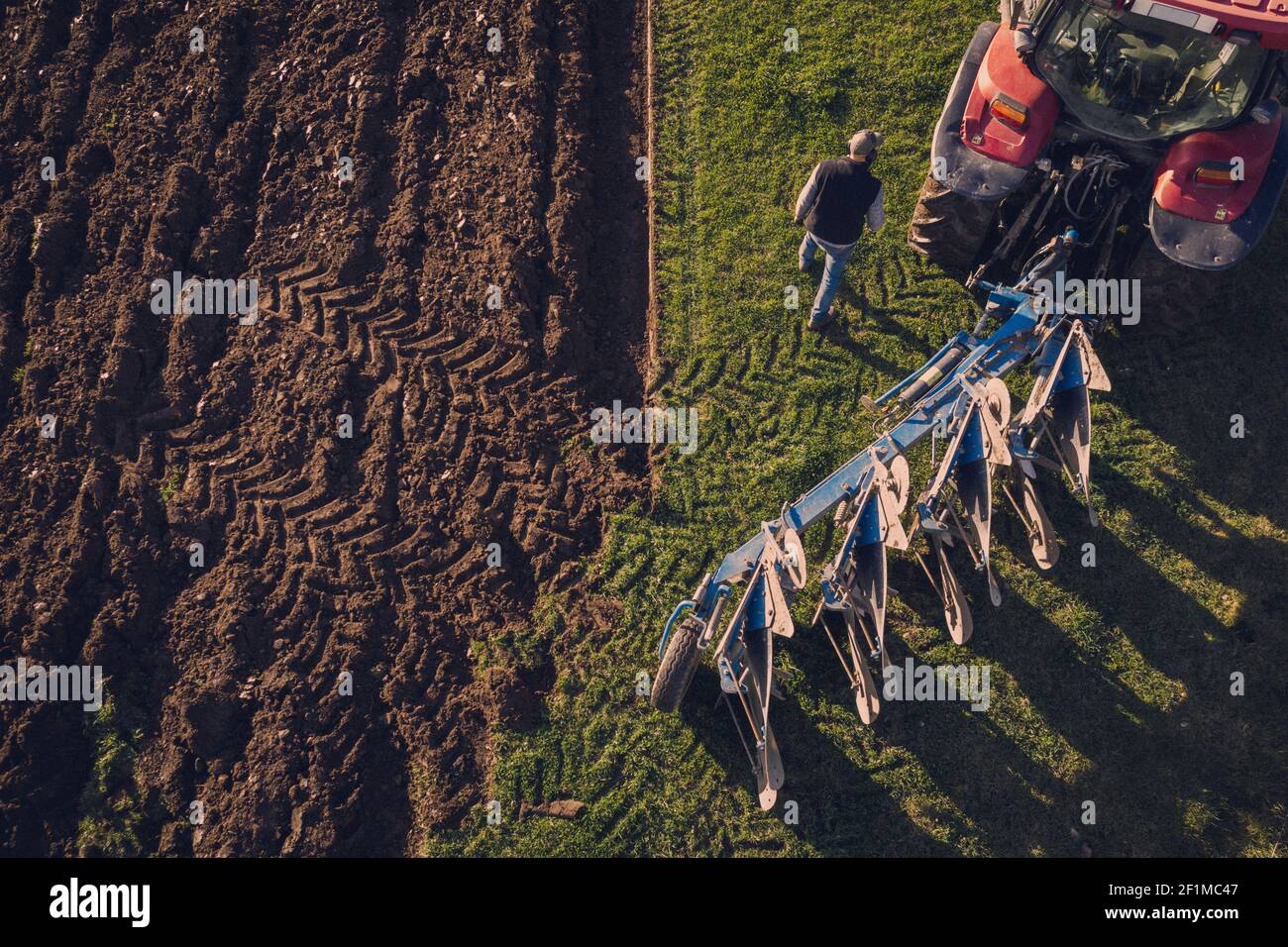 Tractor plowing field Stock Photo - Alamy