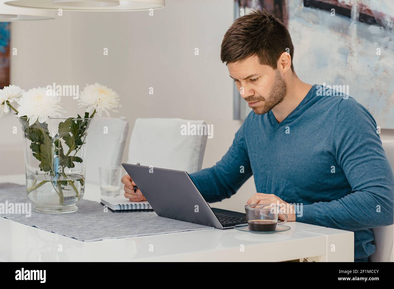 Man using laptop at home Stock Photo - Alamy