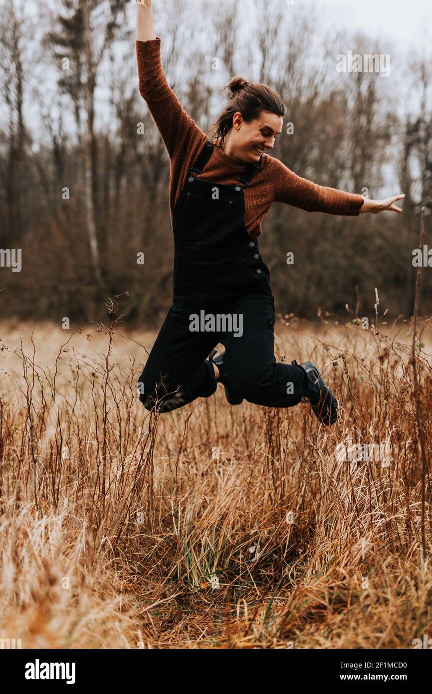 Happy woman jumping hi-res stock photography and images - Alamy